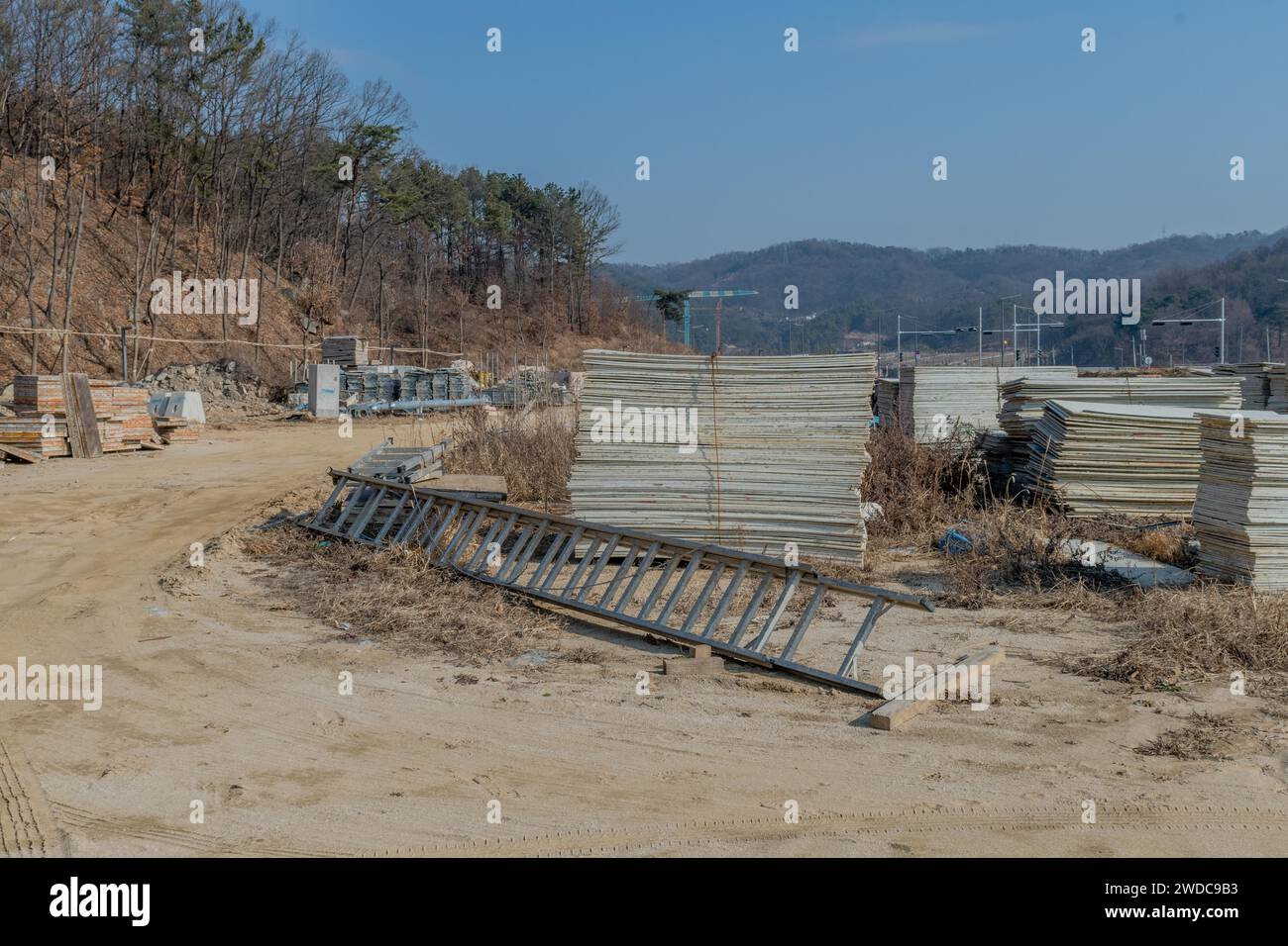 Metal ladder laying on ground at staging area for new construction ...