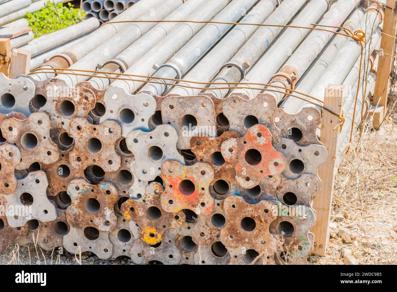 Scaffolding poles stacked neatly at staging area for construction ...
