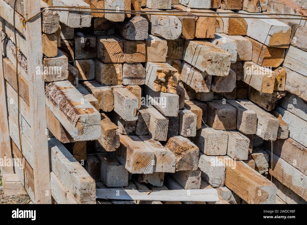 Sections of lumber used in concrete work stack in bin at project ...