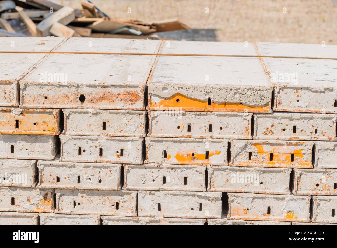 Closeup of metal forms used in concrete work stacked neatly at staging ...