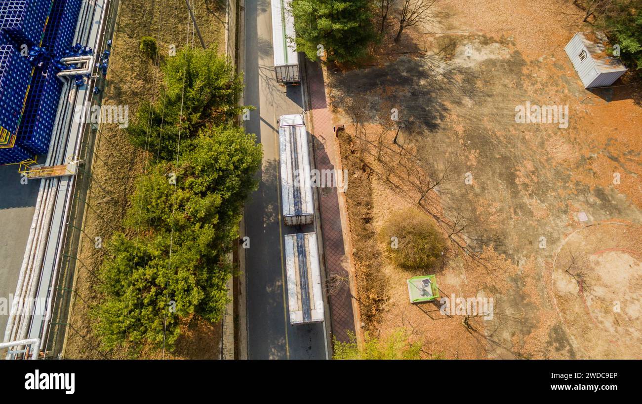 Aerial photo of tractor trailer trucks parked on side of two lane road ...