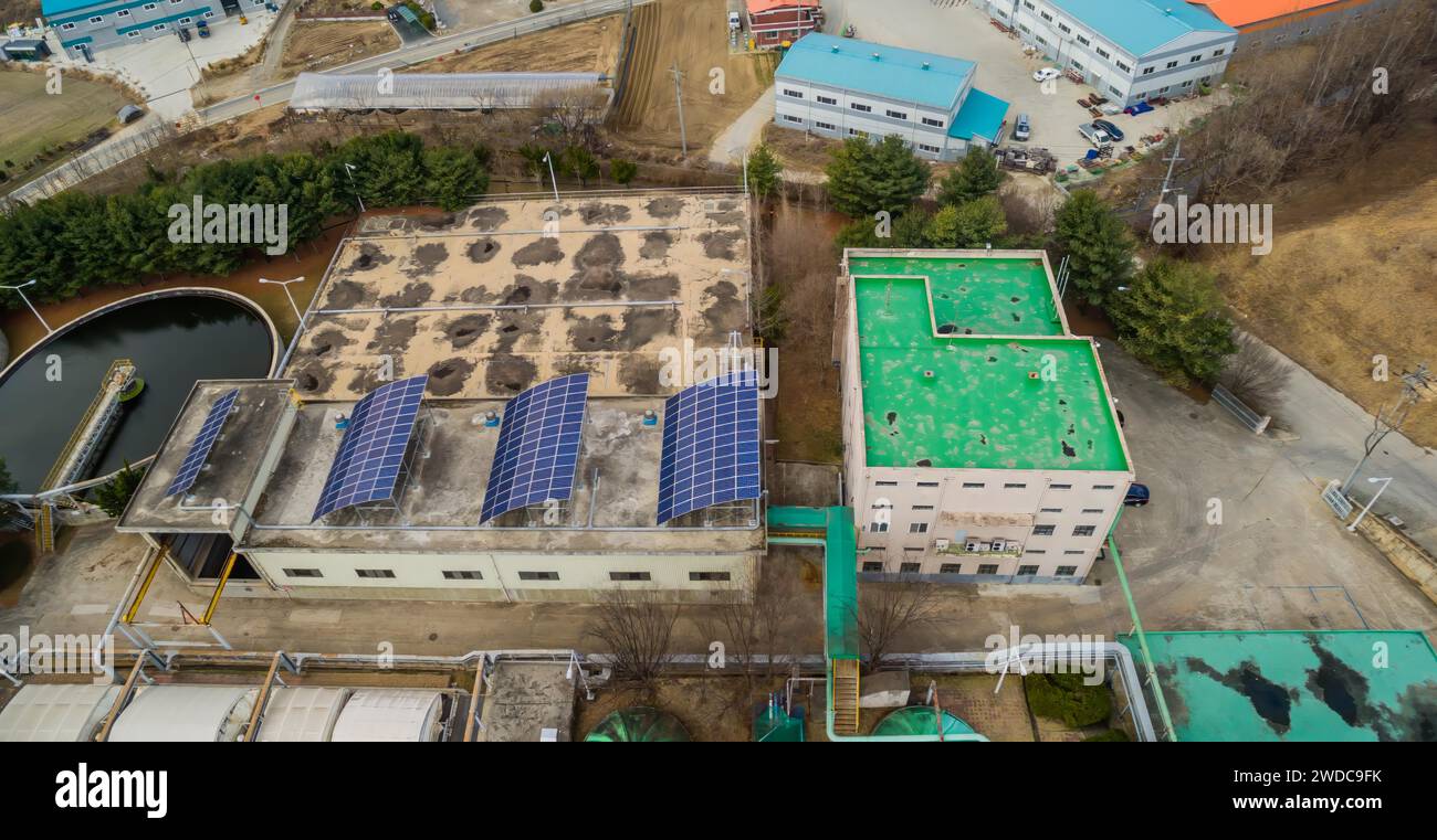 Aerial view of solar panels on rooftop of building at water treatment ...