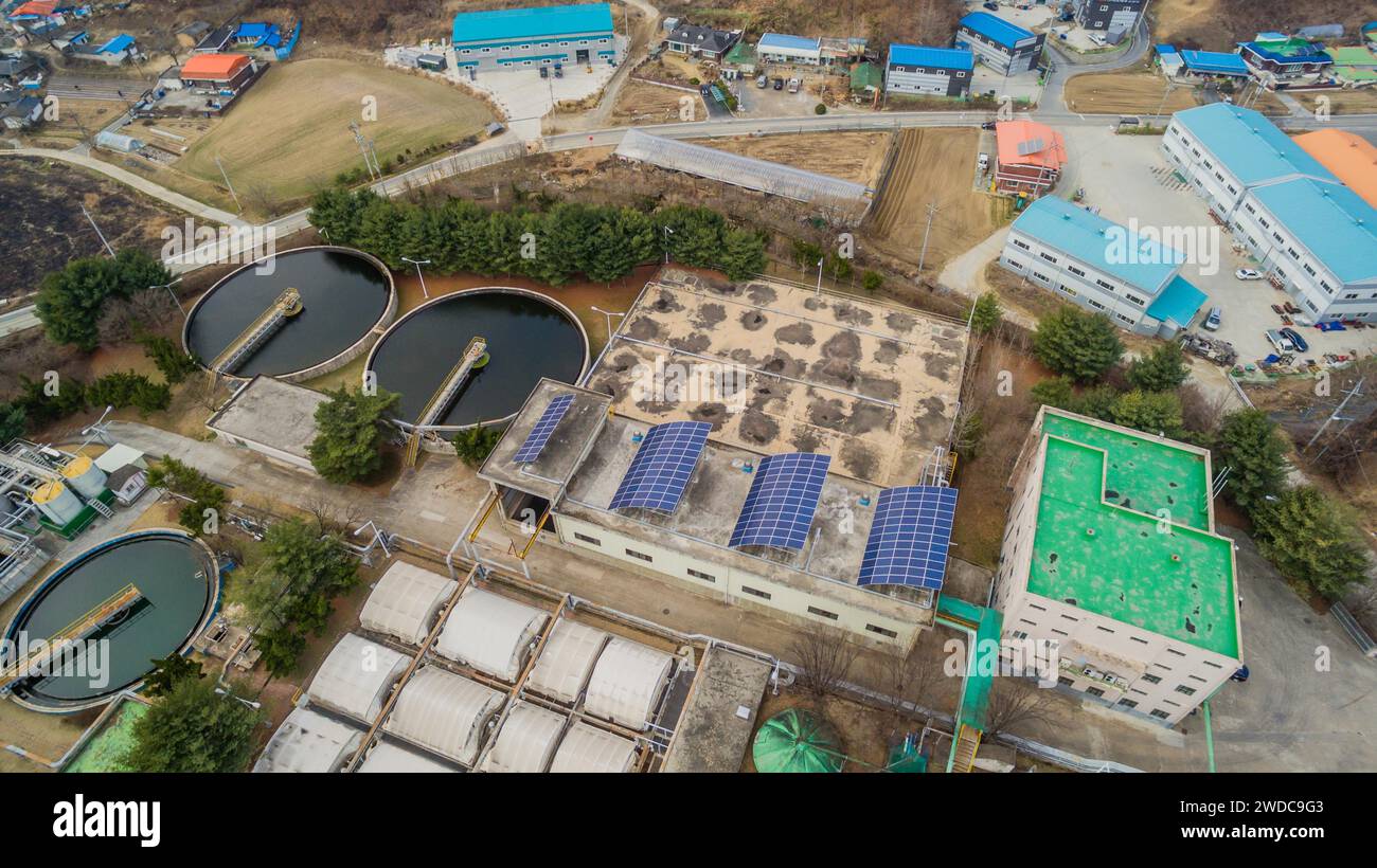 Aerial view of pools of water and buildings at water treatment plant in ...