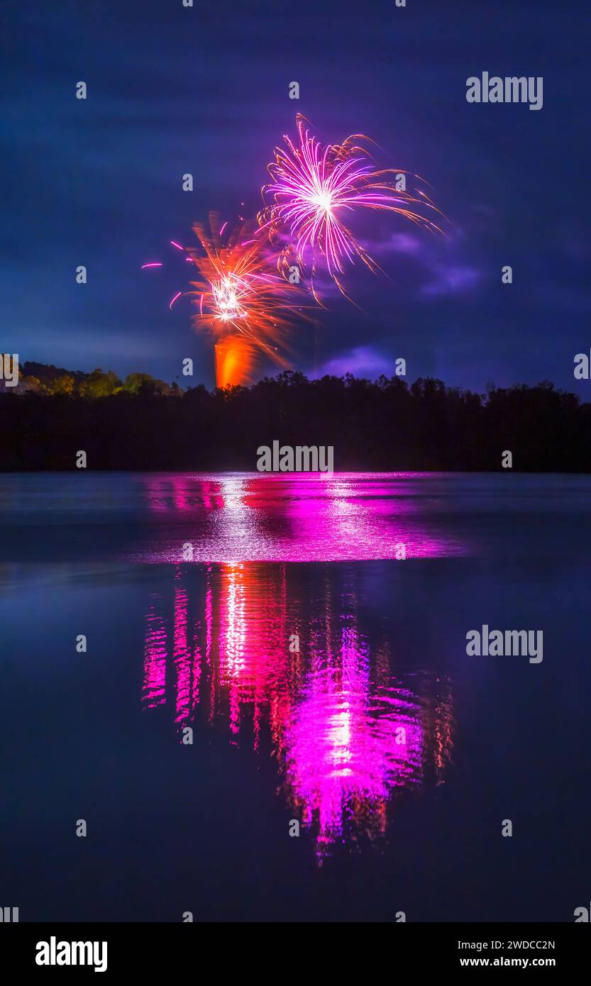 Majestic magentic fireworks balls in dark night sky over Lake Macquarie ...