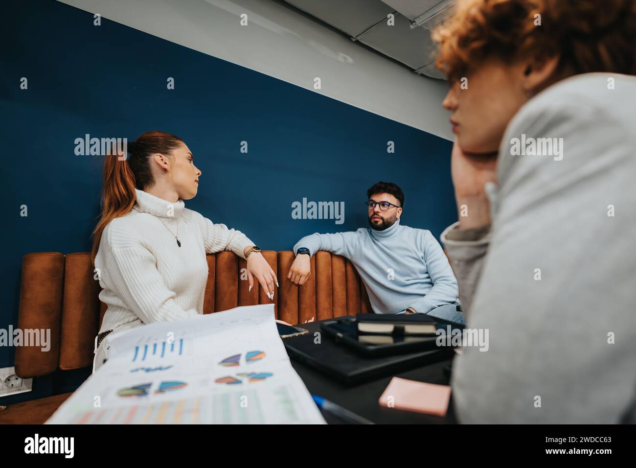 Business Professionals Collaborating In A Creative Office Analyzing Stats And Brainstorming