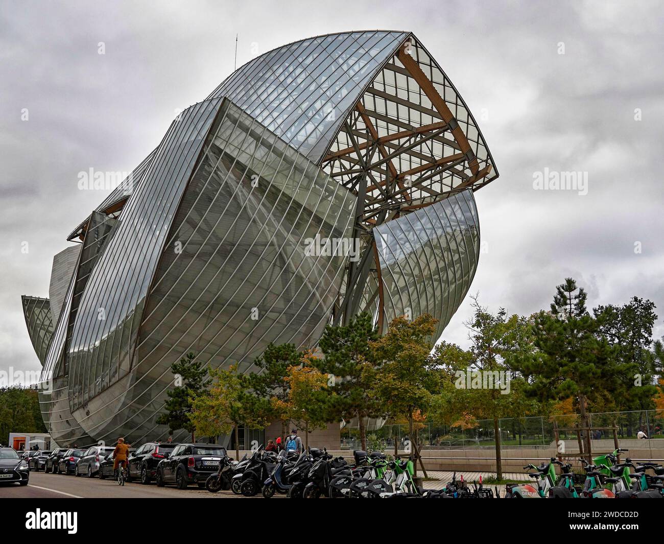 A futuristic building with a glass facade and metal structures under a ...