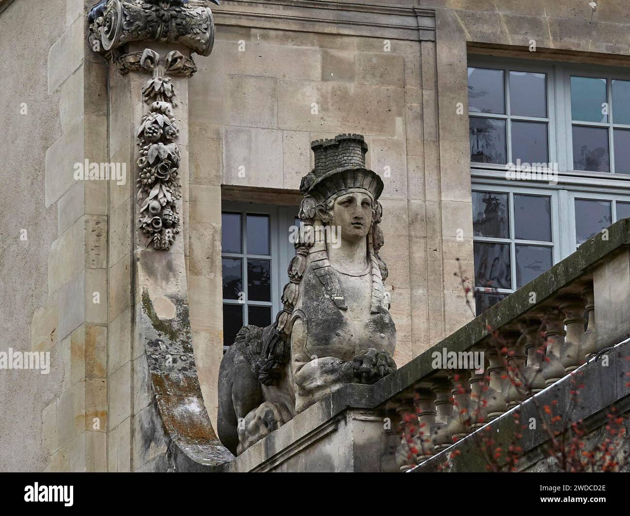 Stone sculpture of a woman with a top hat as a detail on a classical ...