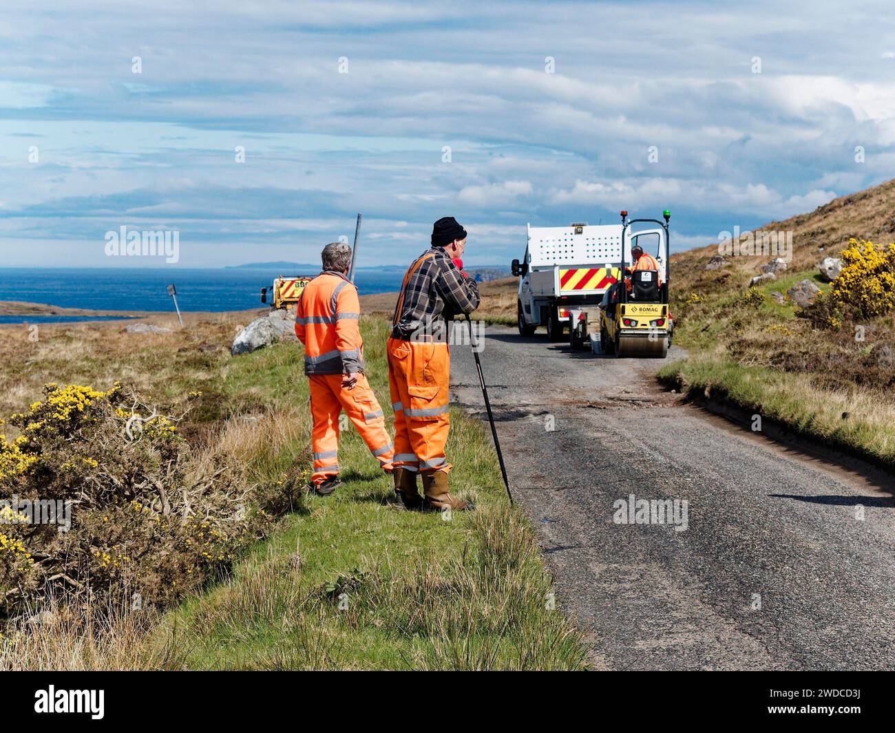 Road workers repairing potholes on the road from Laide to Mellon ...
