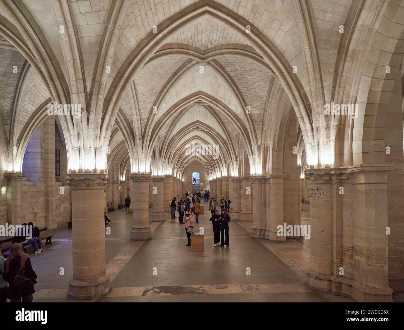 People visit a historic room with an impressive Gothic vaulted ceiling ...