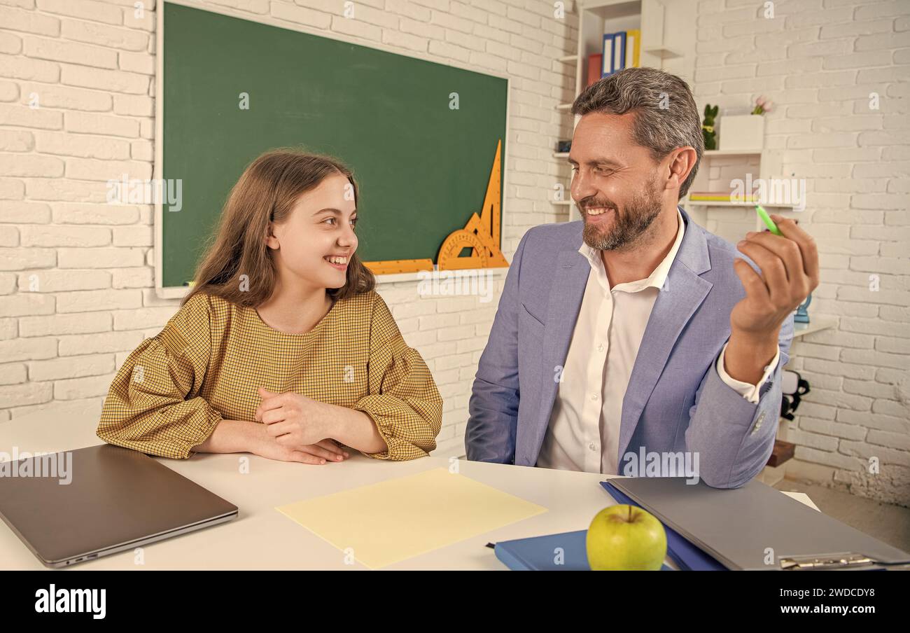 positive child study in classroom with tutor Stock Photo - Alamy