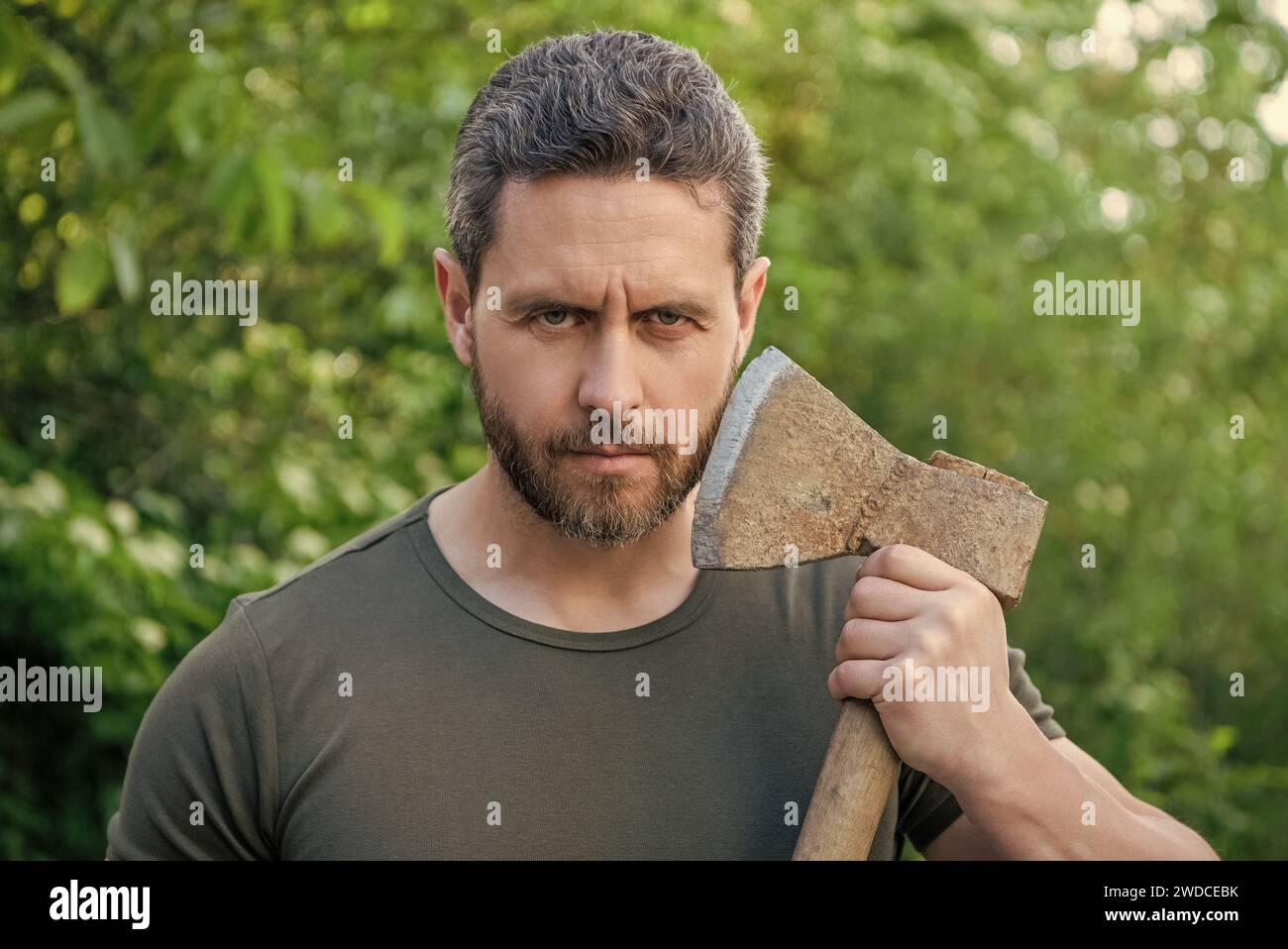 face of masculine guy with axe outdoor. photo of masculine guy with axe ...