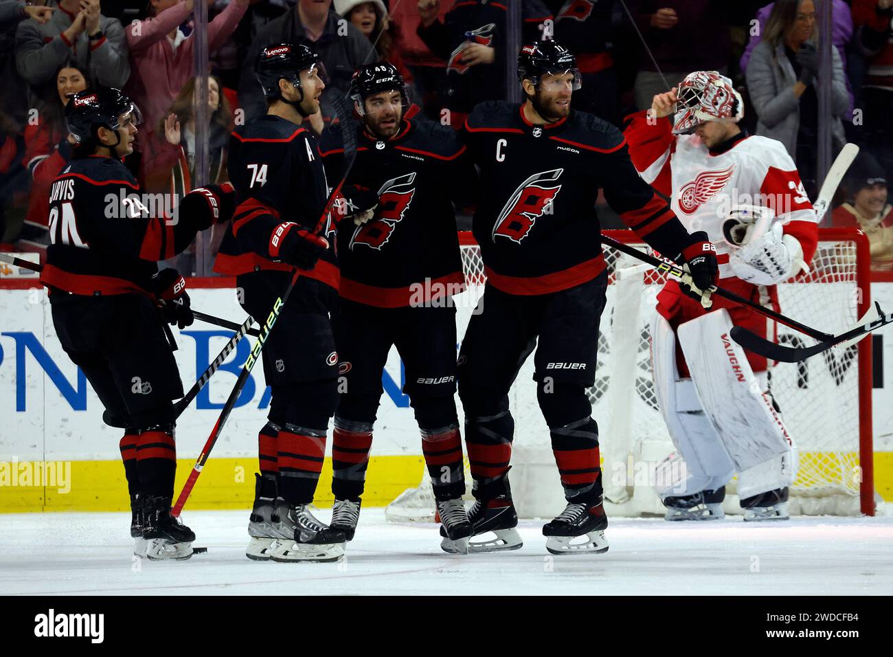 Carolina Hurricanes celebrate after a goal by Jordan Martinook, center ...