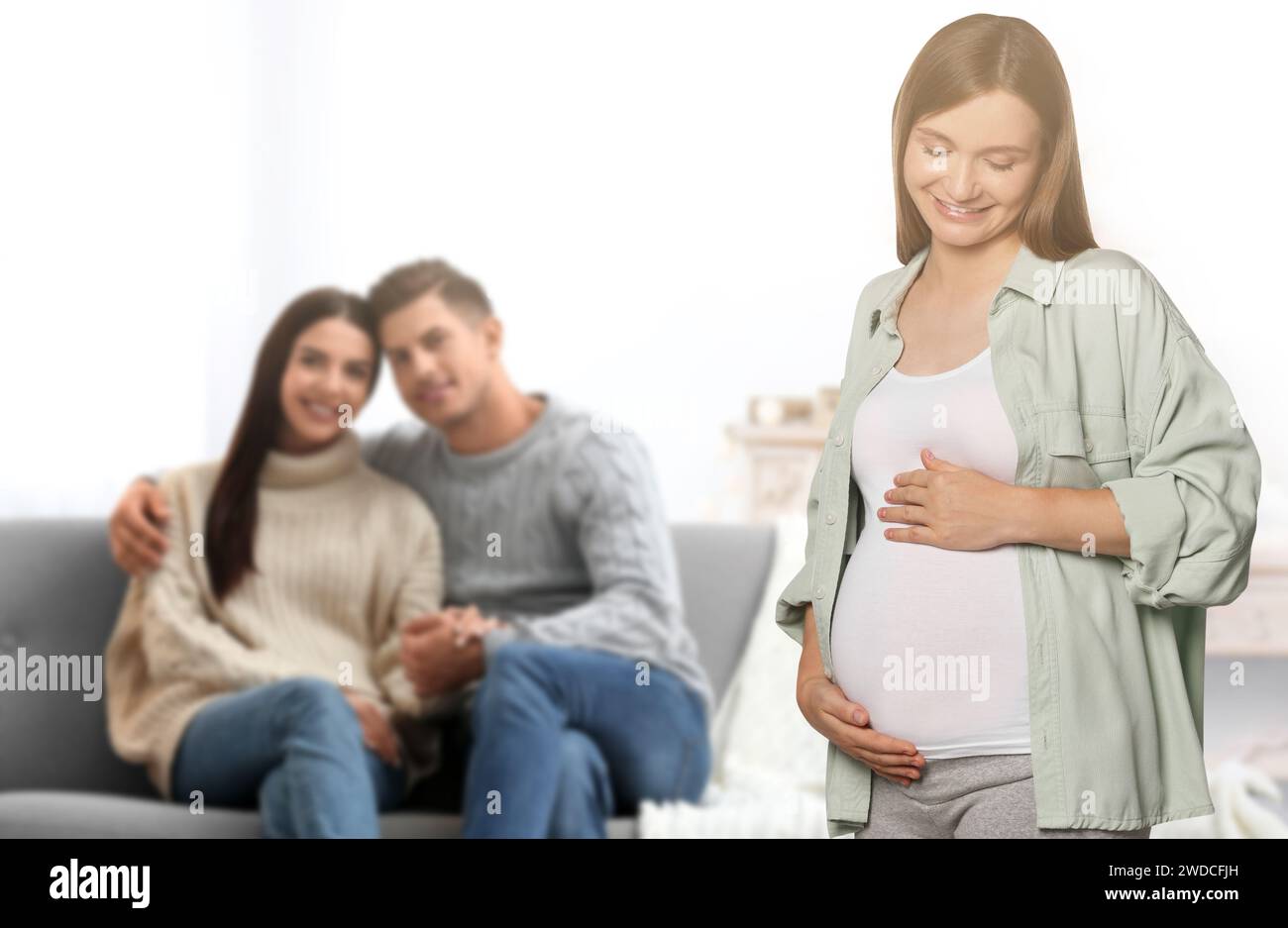 Surrogate mother and intended parents in room Stock Photo - Alamy
