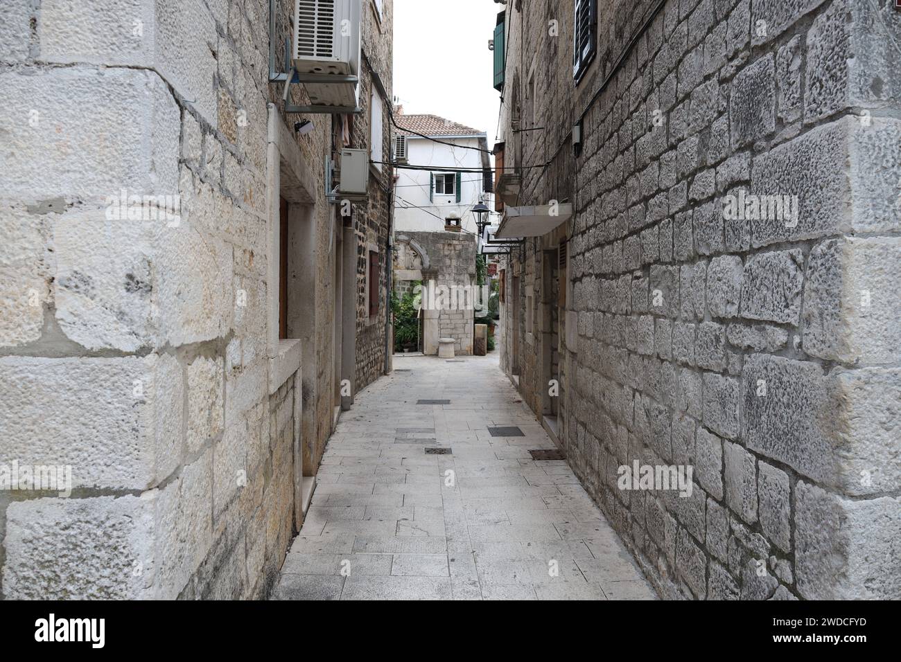 Picturesque view of passage between old buildings in city Stock Photo ...