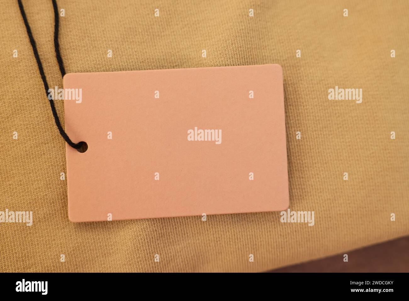 Cardboard tag on garment, closeup. Space for text Stock Photo - Alamy
