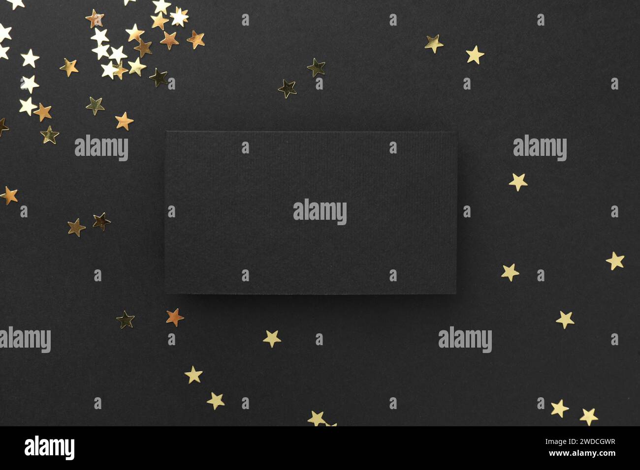 Blank business card and confetti on black background, top view. Mockup ...