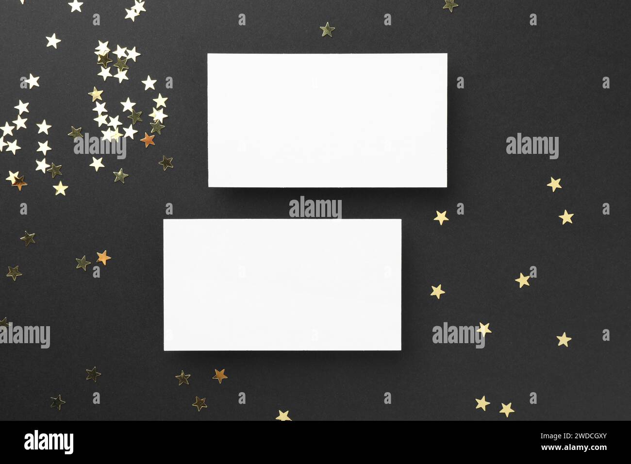 Blank business cards and confetti on black background, top view. Mockup ...
