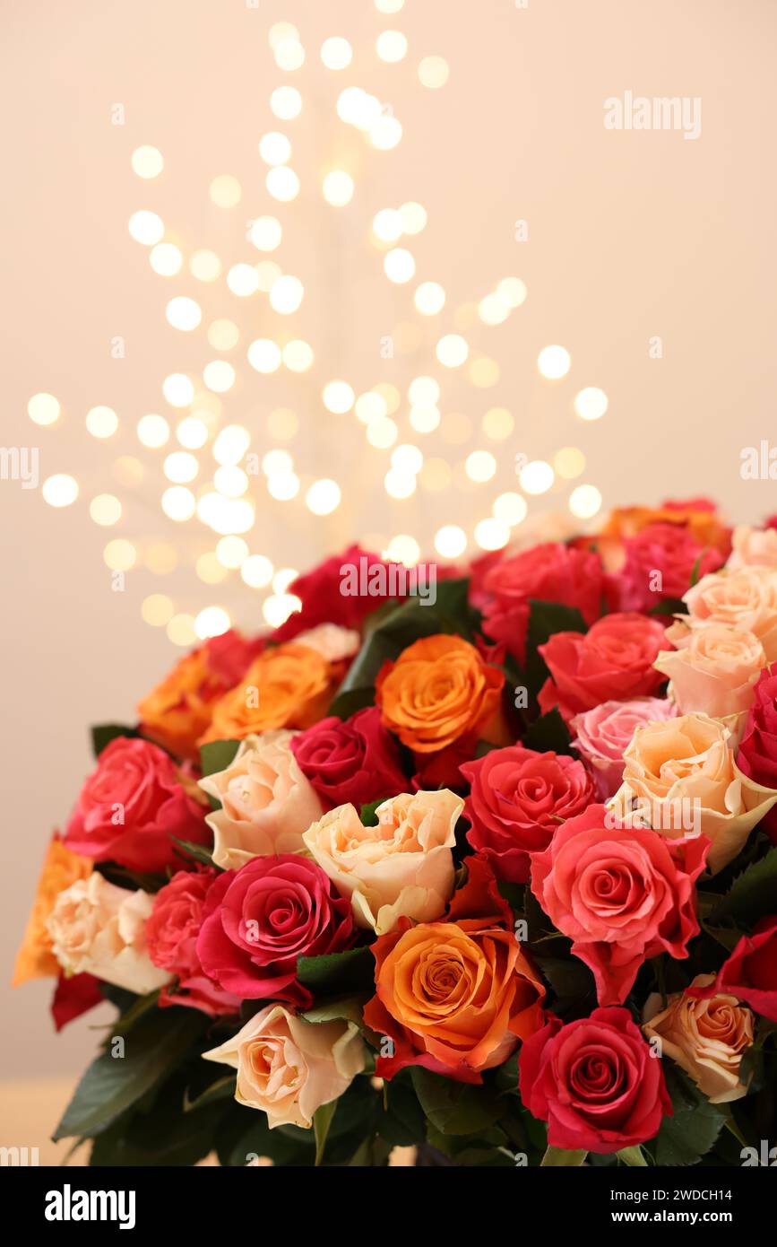 Beautiful bouquet of colorful roses on beige background Stock Photo - Alamy