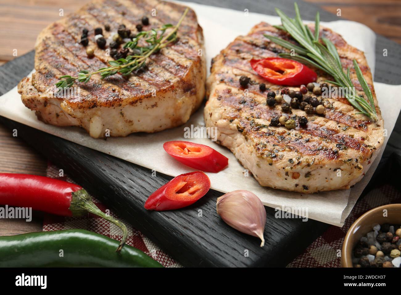 Delicious grilled pork steaks with spices on table, closeup Stock Photo ...