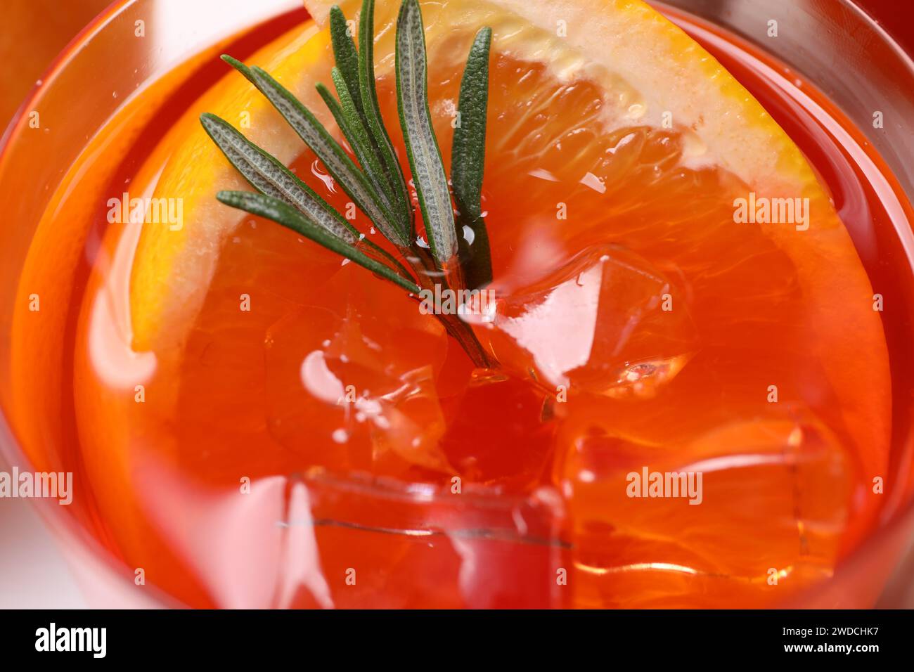 Aperol spritz cocktail, ice cubes, rosemary and orange slices in glass ...