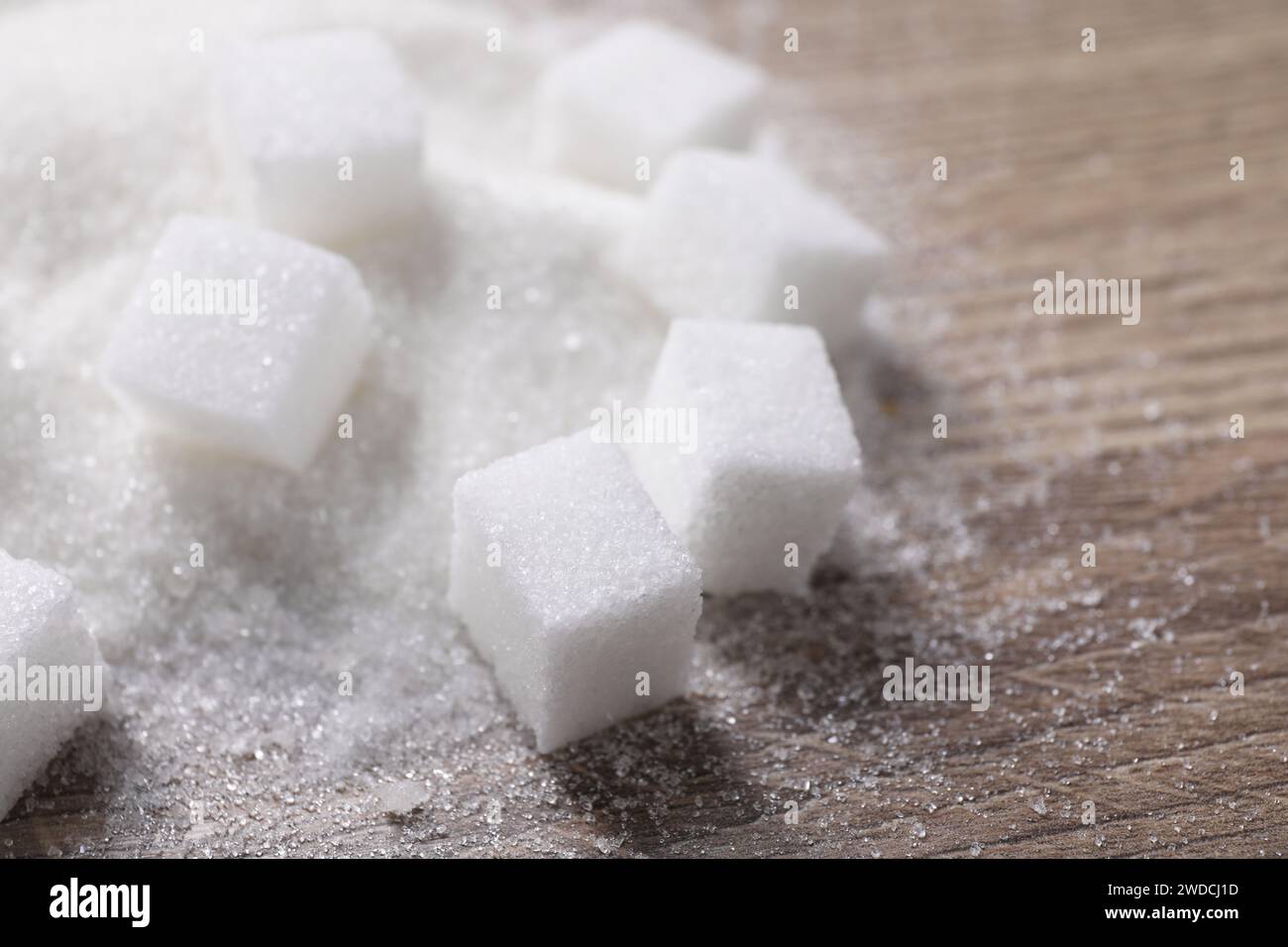 Different types of white sugar on wooden table, closeup. Space for text ...