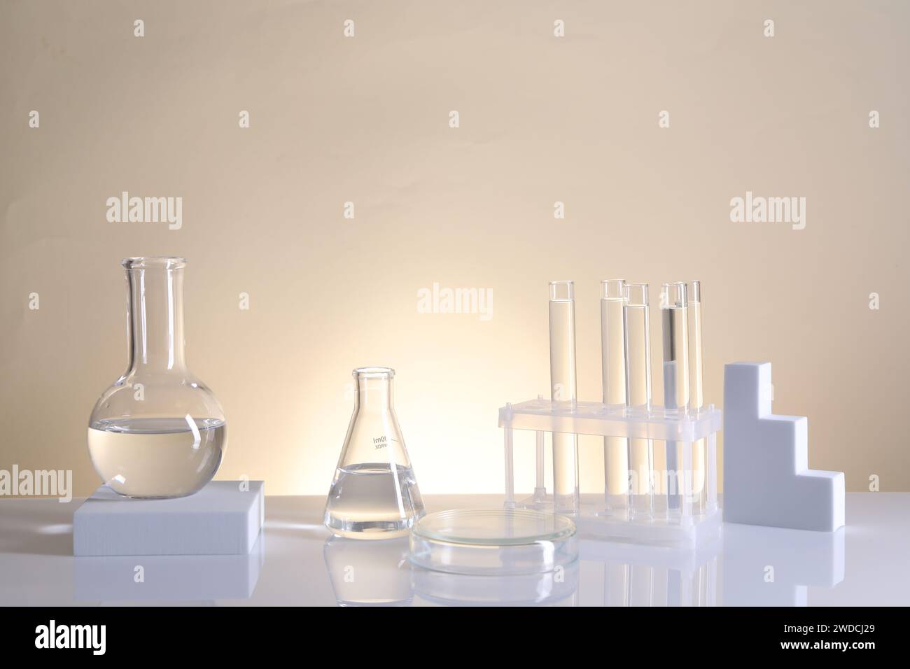 Laboratory analysis. Different glassware on table against beige ...