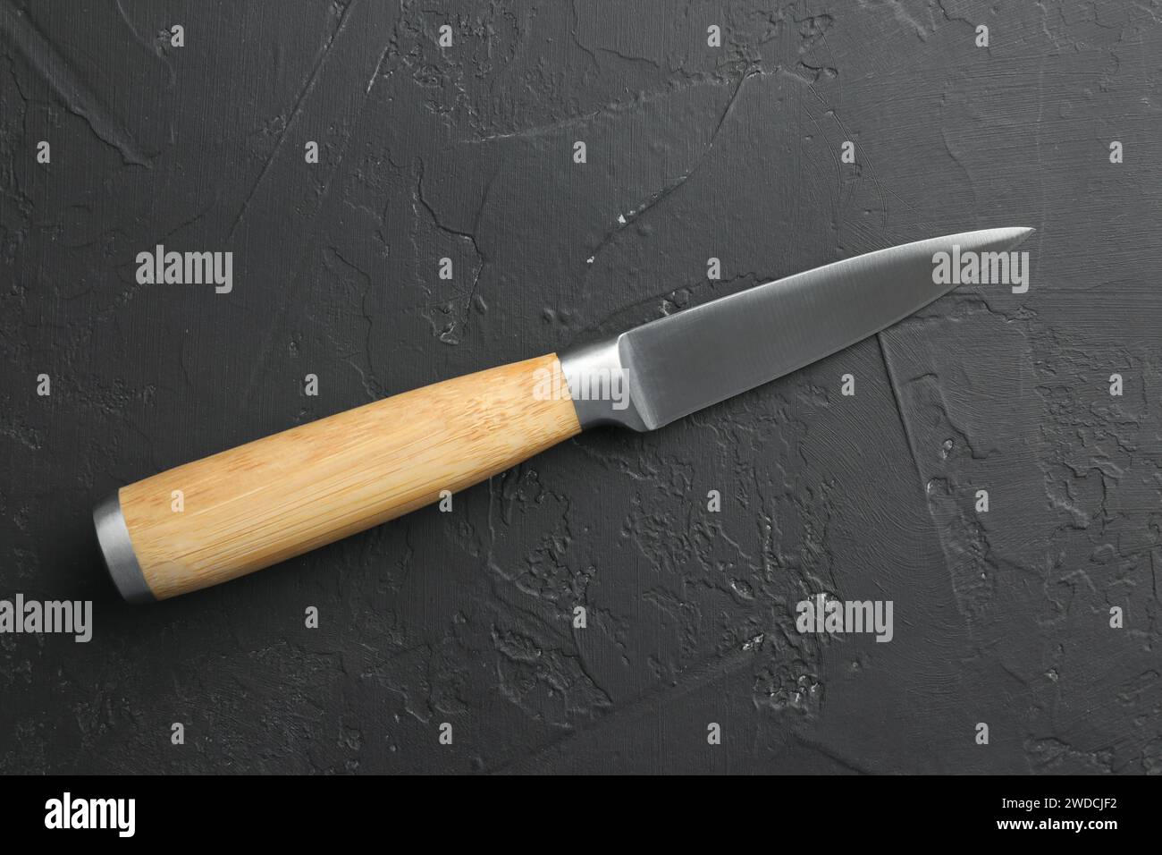One sharp knife on dark textured table, top view Stock Photo - Alamy