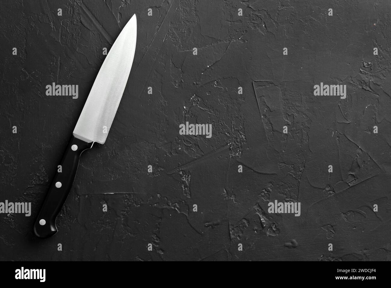 One sharp knife on dark textured table, top view. Space for text Stock ...
