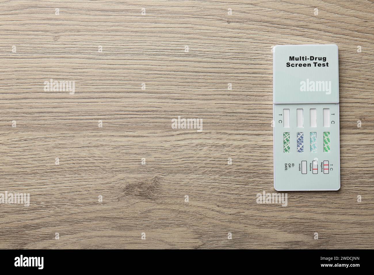 Multi-drug screen test on light wooden table, top view. Space for text ...