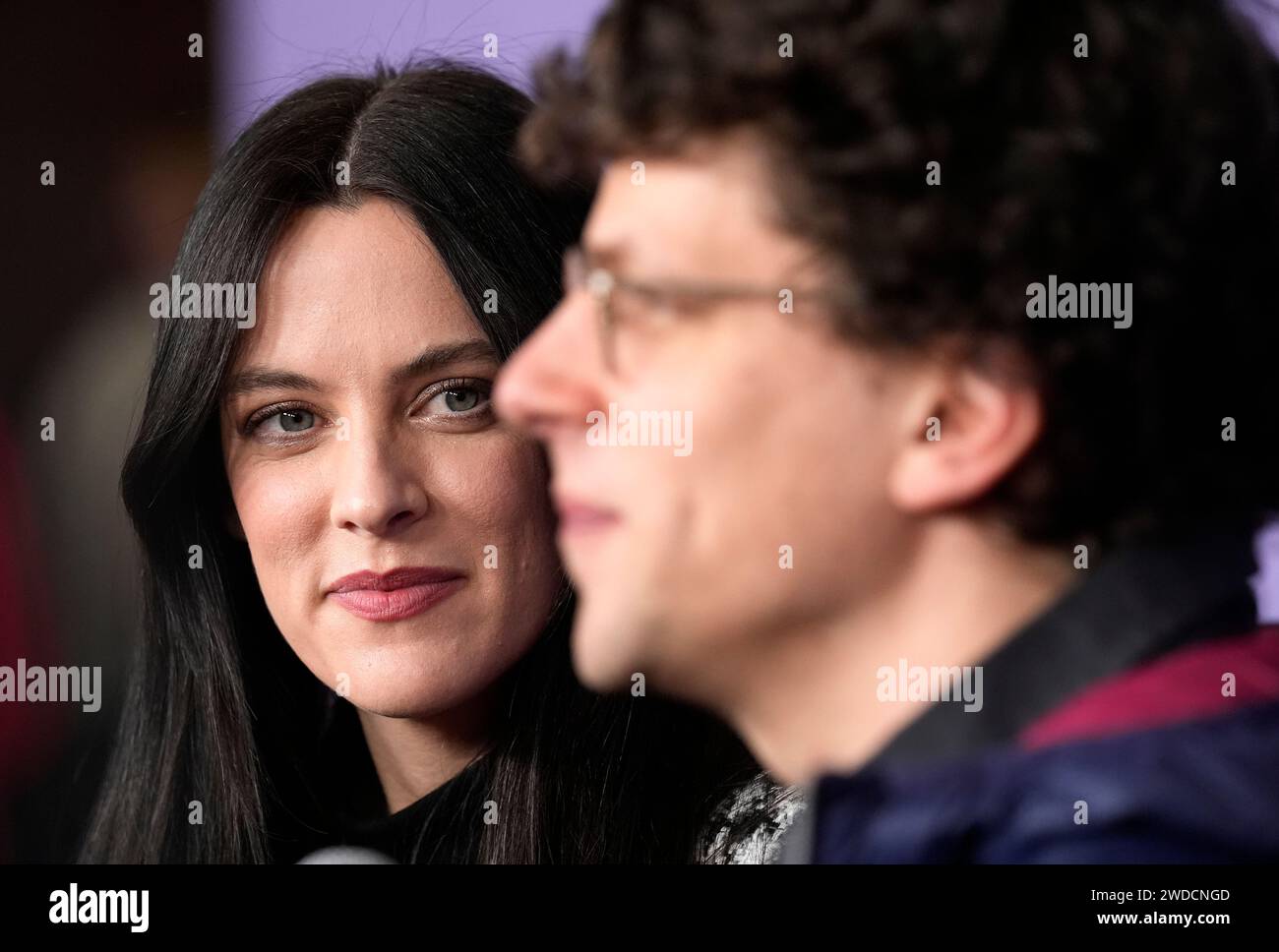 Riley Keough, left, a cast member in "Sasquatch Sunset," looks over at ...