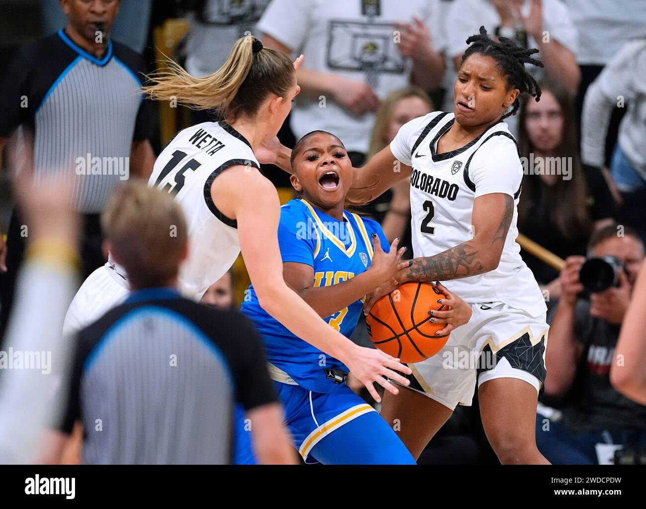 UCLA guard Londynn Jones, center, competes for control of the ball with ...