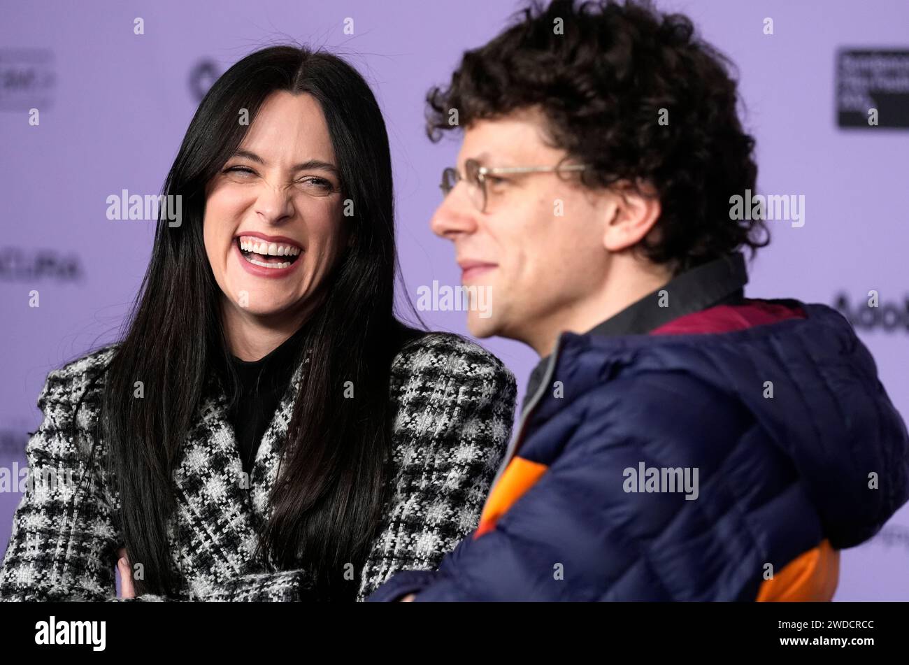 Riley Keough, left, reacts to Jesse Eisenberg as they are interviewed ...