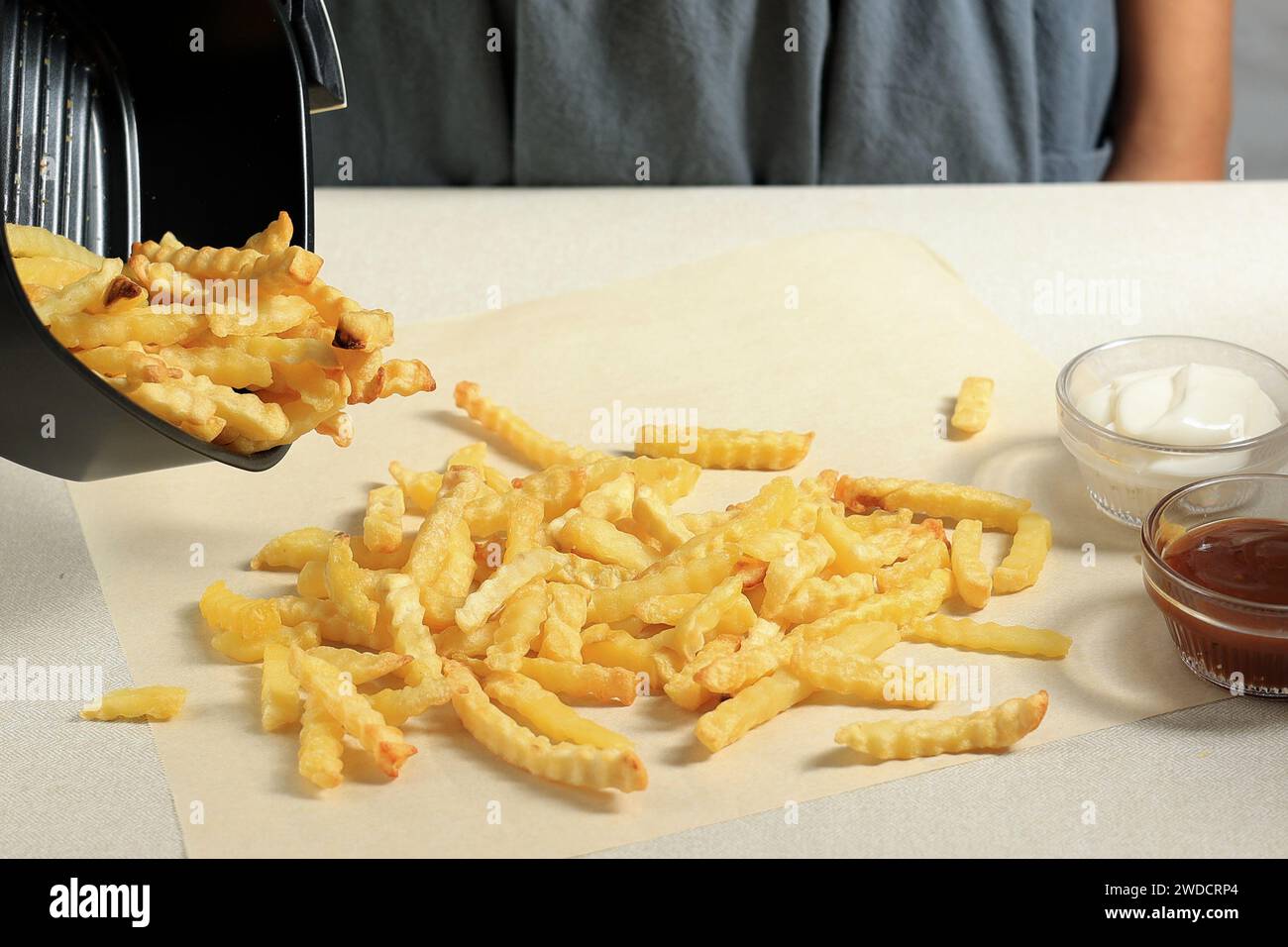 Pour Wavy Potato Crinkle Cut from Airfryer Tray to the Table. Cooking ...