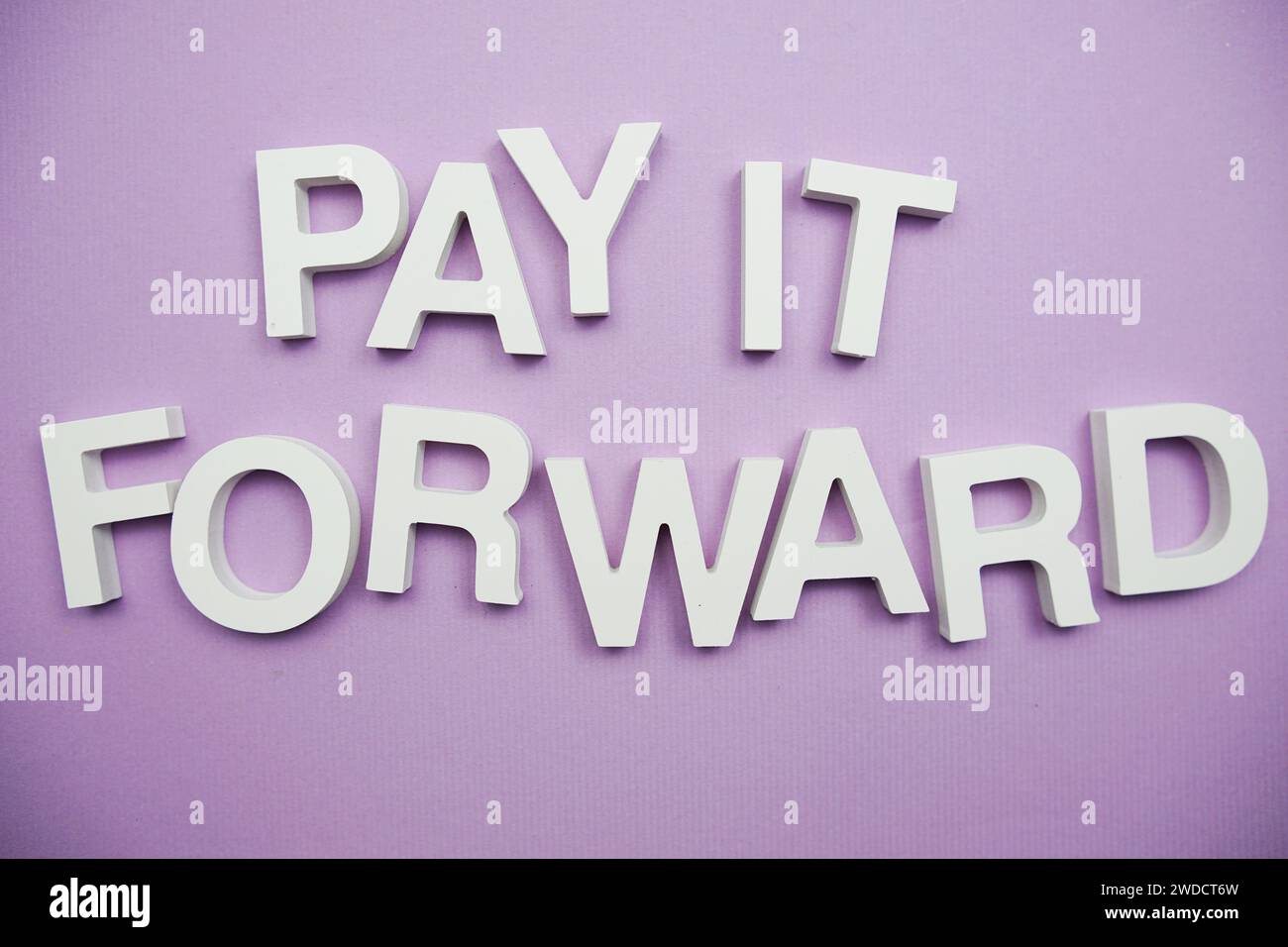 Pay It Forward alphabet letters on purple background Stock Photo - Alamy