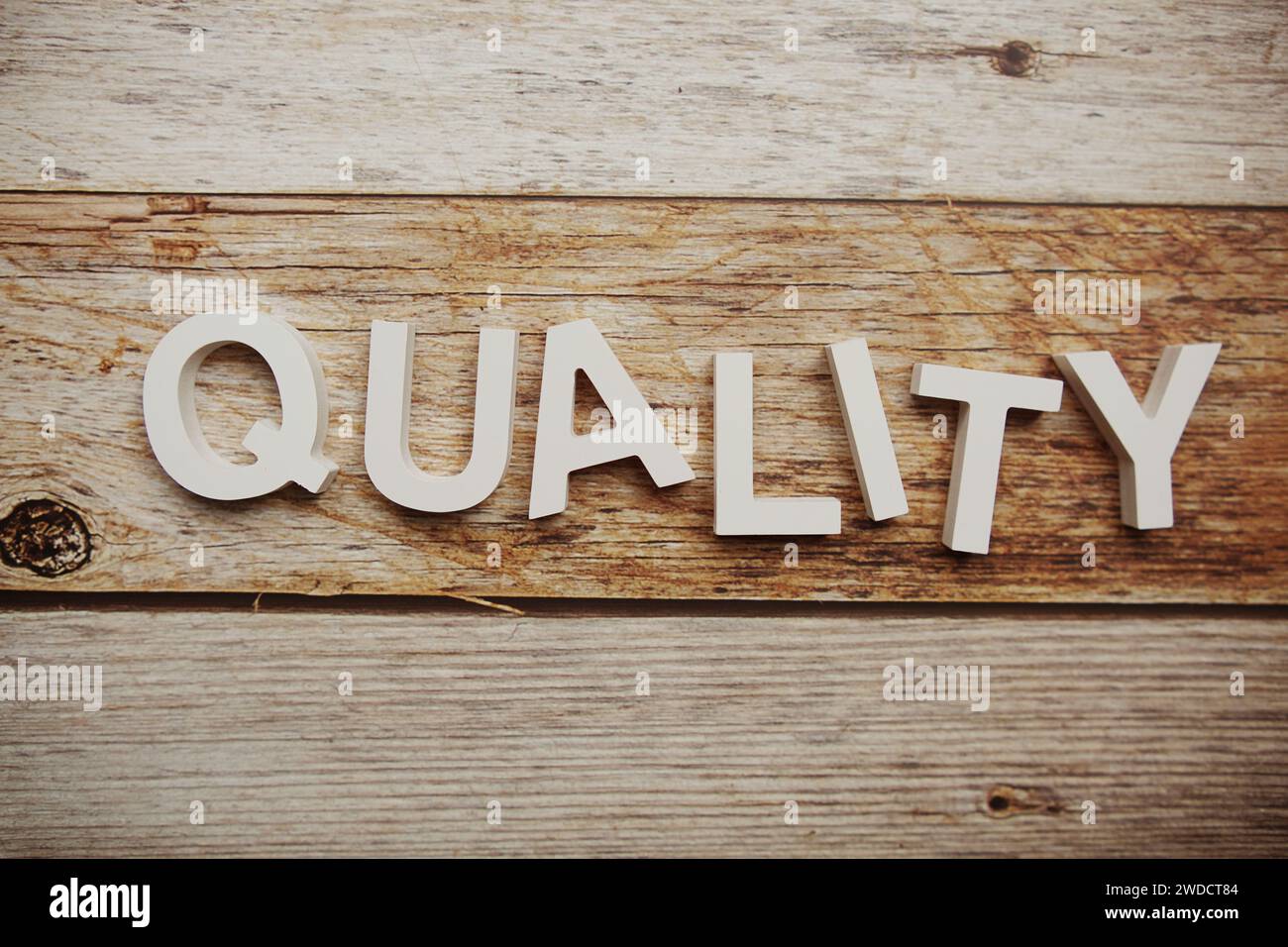 Quality alphabet letters on wooden background Stock Photo - Alamy