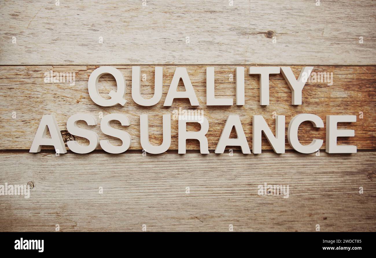 Quality assurance alphabet letters on wooden background Stock Photo - Alamy