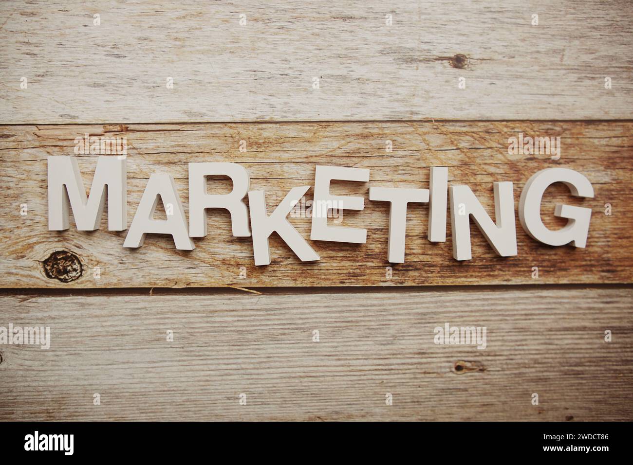 Marketing alphabet letters on wooden background Stock Photo - Alamy