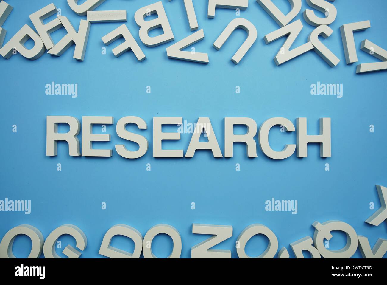 Research alphabet letters on blue background Stock Photo - Alamy