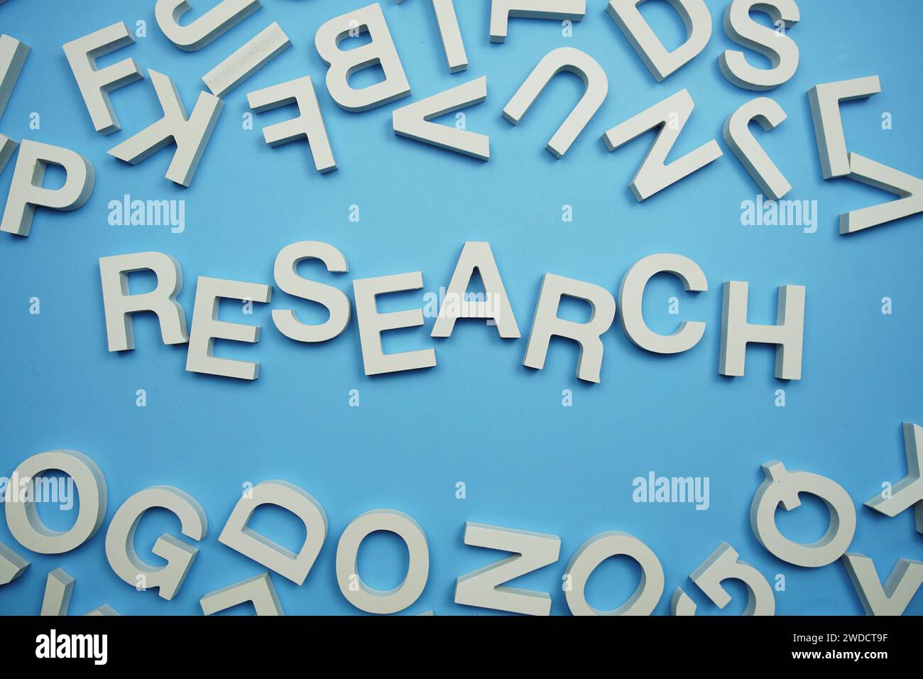 Research alphabet letters on blue background Stock Photo - Alamy