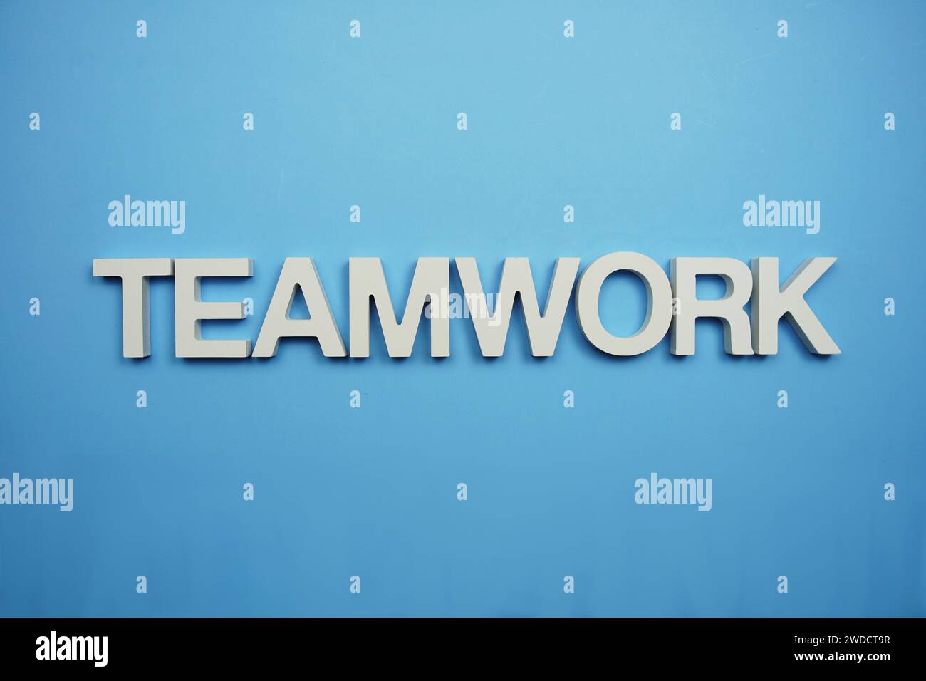 Teamwork alphabet letters on blue background Stock Photo - Alamy