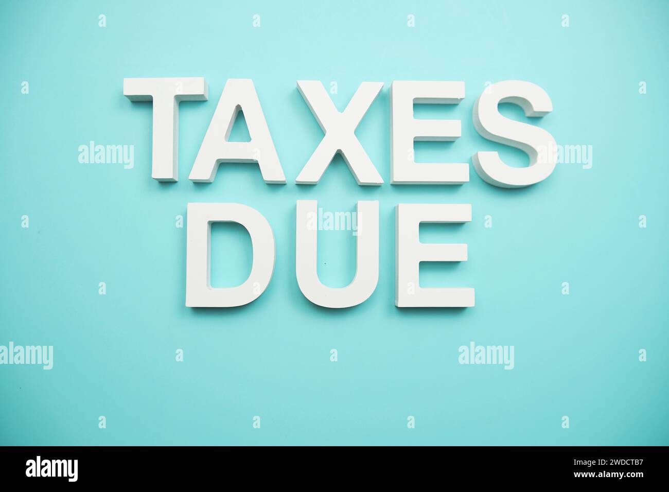 Taxes Due alphabet letters on blue background Stock Photo - Alamy