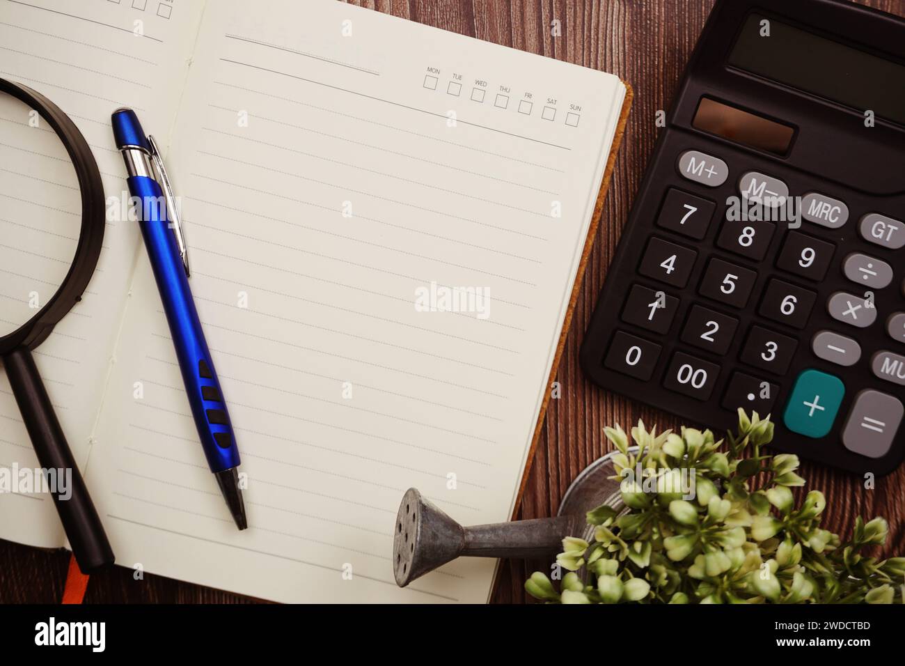 Planning schedule with magnifying glass and calculator on wooden ...