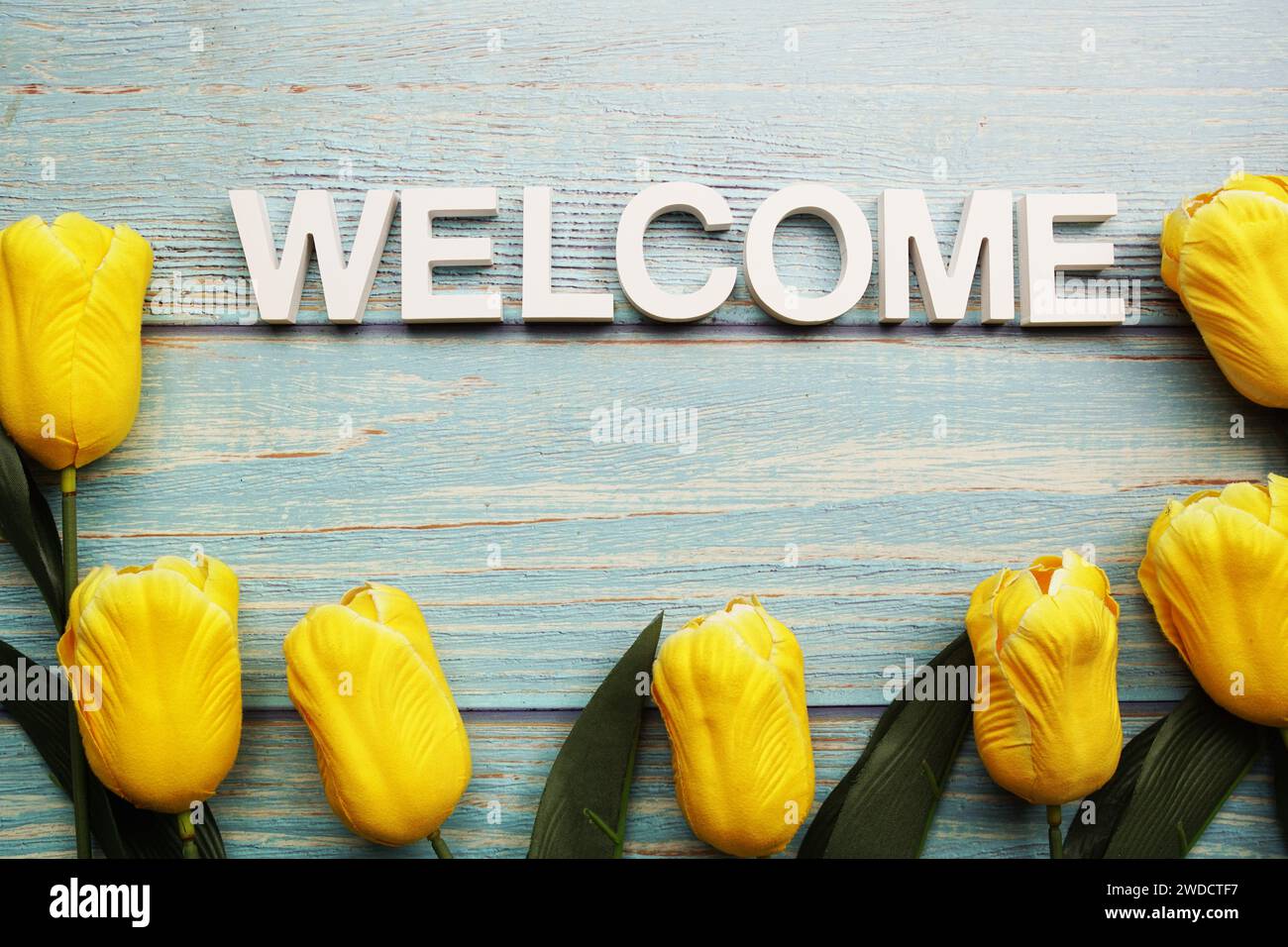 Welcome alphabet letters with tulip flower on wooden background Stock ...
