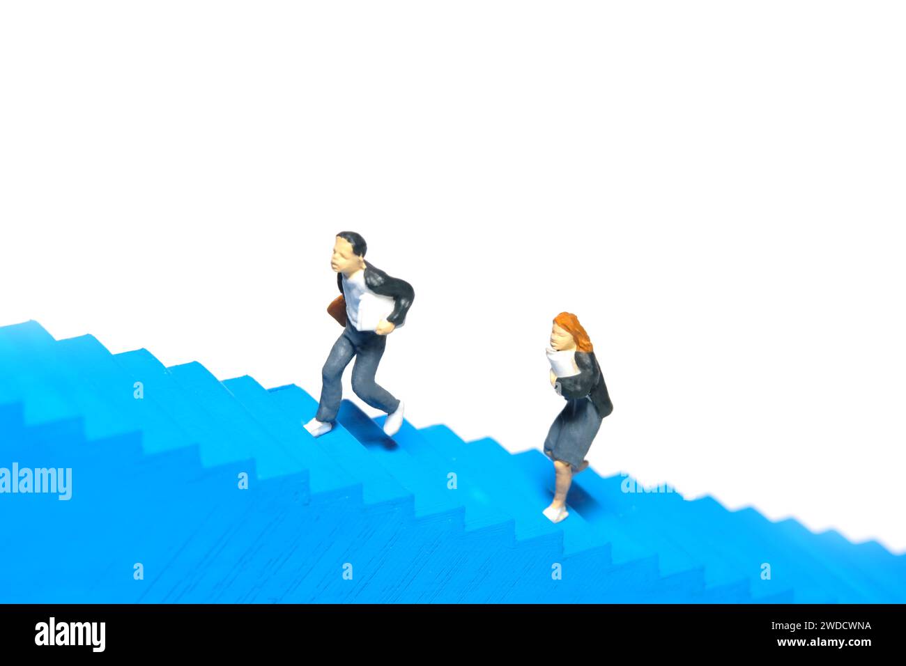 Miniature people toy figure photography. A boy and girl pupil student ...