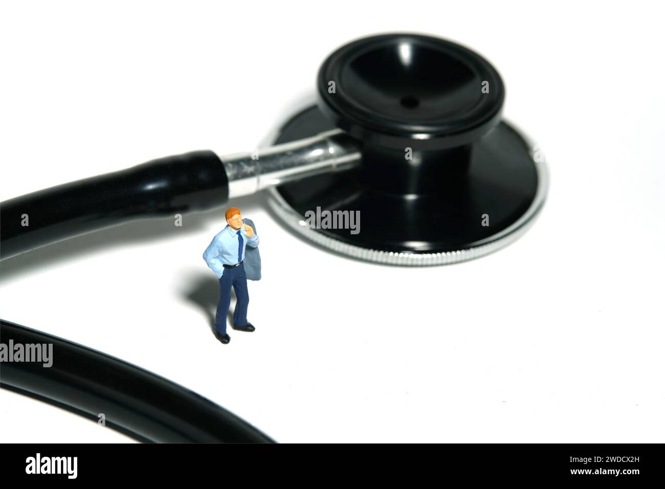 Miniature tiny people toy figure photography. A men standing in front ...