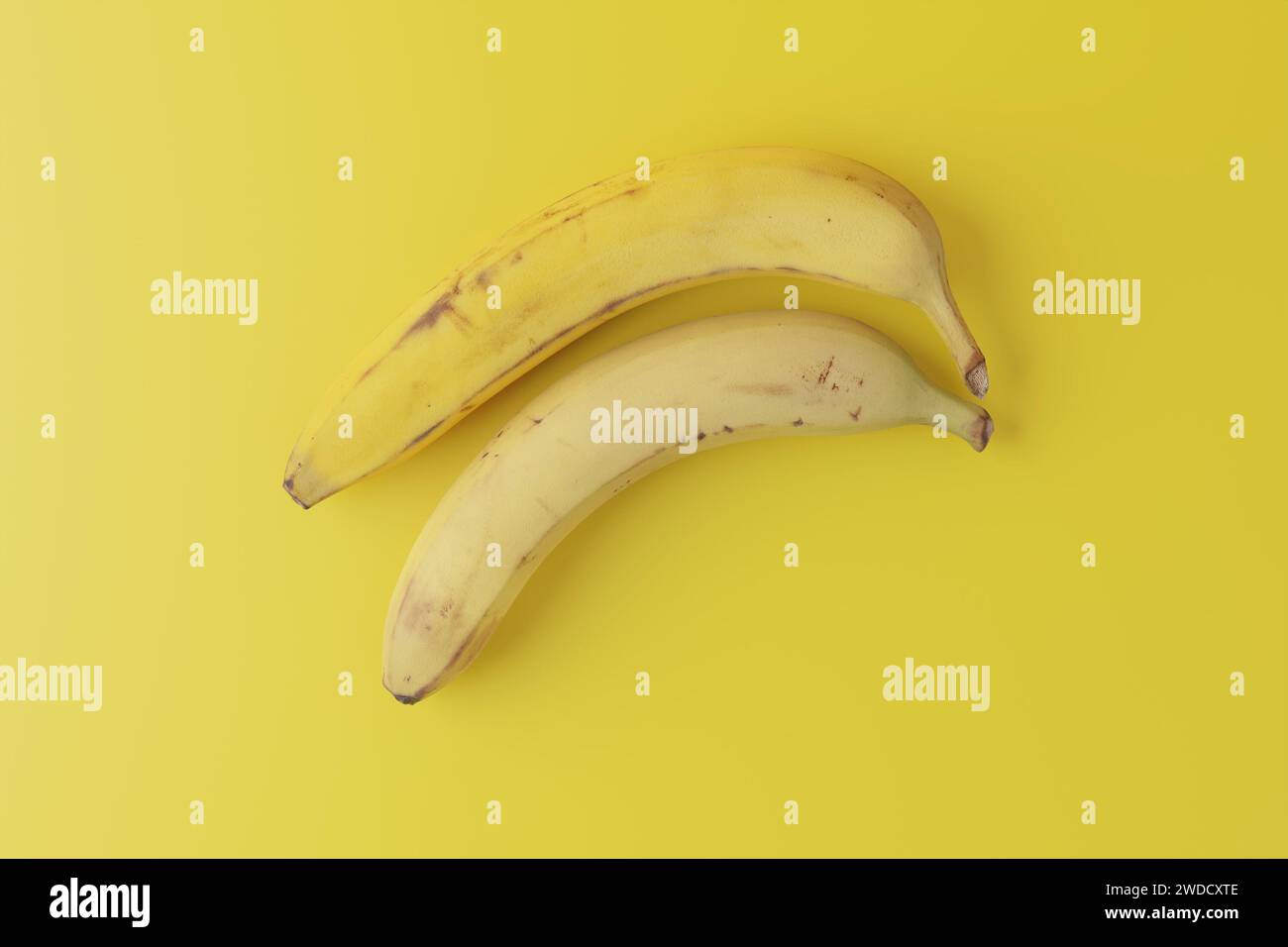 Photograph of Fresh banana on solid yellow background Stock Photo - Alamy