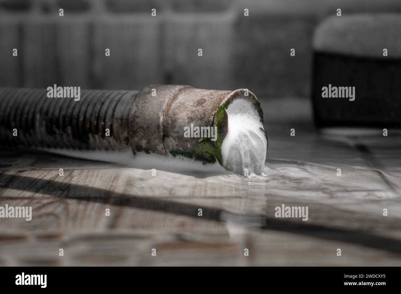 A pipe with flowing foamy water. Water waste Stock Photo - Alamy