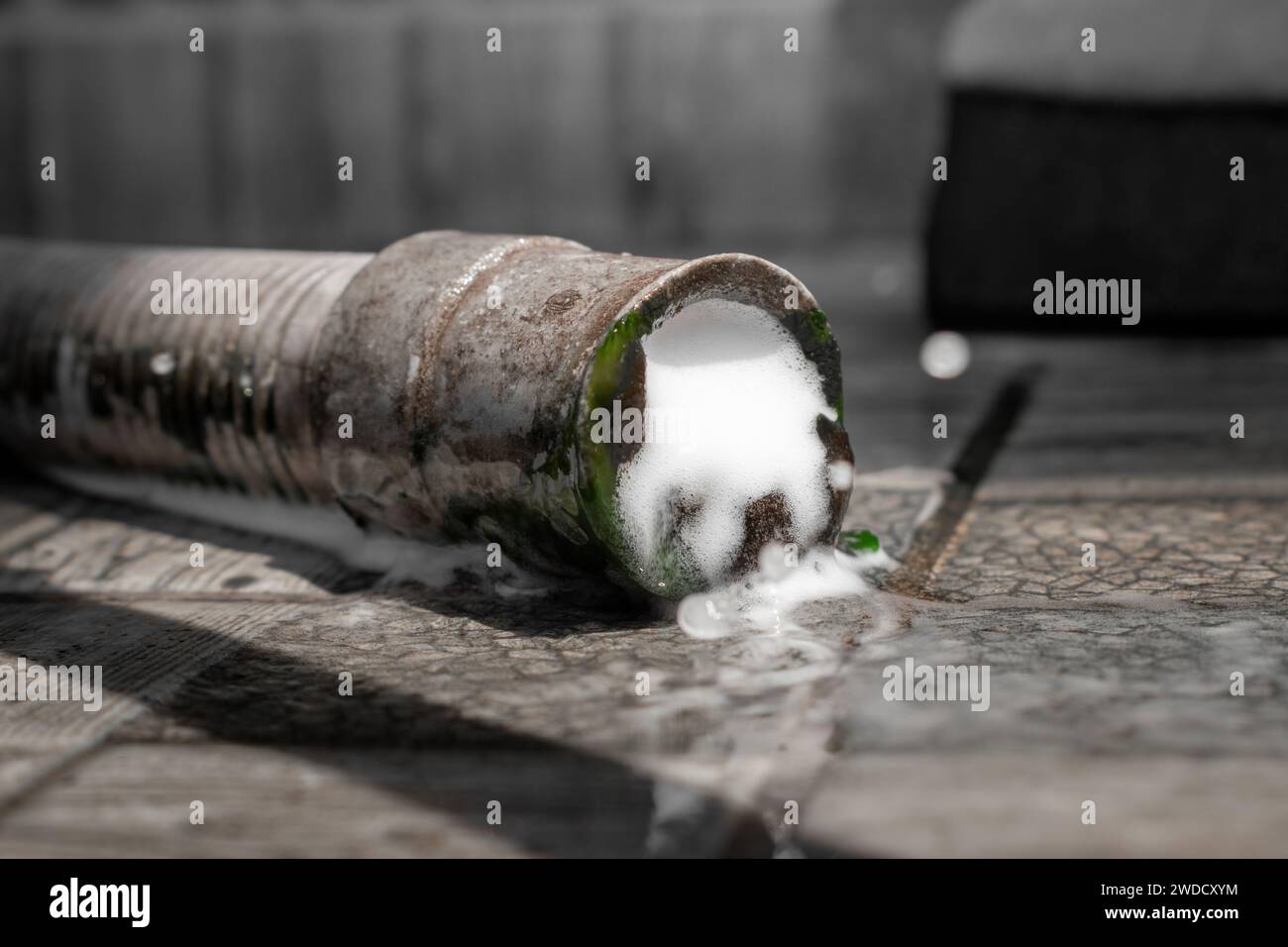 A pipe with flowing foamy water. Water waste Stock Photo - Alamy