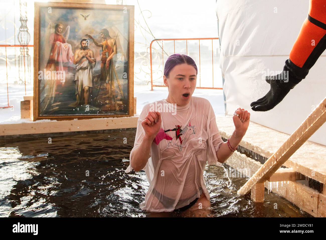 St. Petersburg, Russia. 19th Jan, 2024. A young woman is seen during Epiphany bathing in a font ...