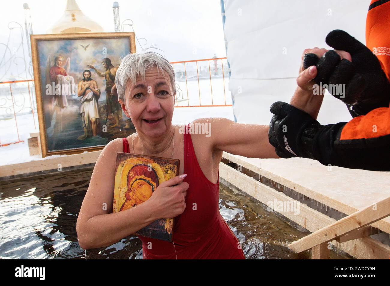 St. Petersburg, Russia. 19th Jan, 2024. A woman with an icon of the ...